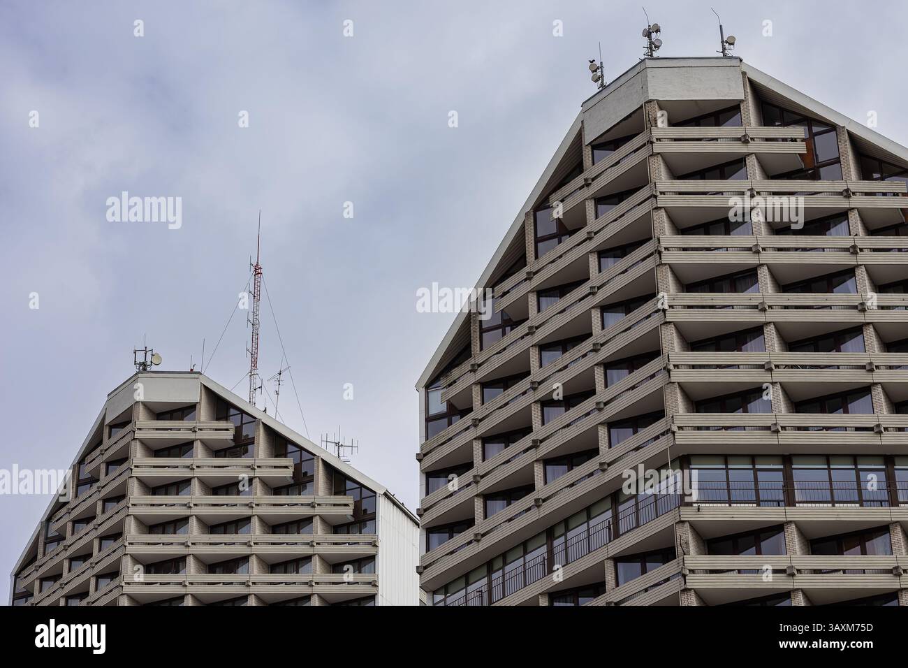 Modern high-rise buildings with satellite communication systems and antennas on rooftops under ...