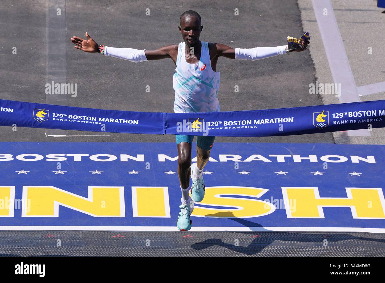 John Korir, of Kenya, breaks the tape to win the Boston Marathon, Monday, April 21, 2025, in ...