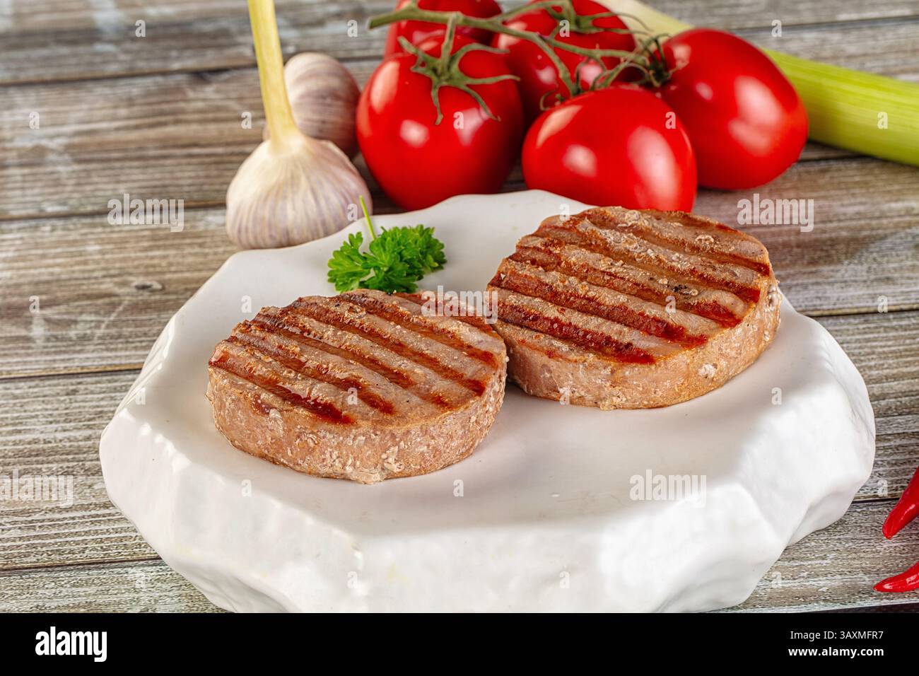 Grilled tuna steak fillet round medallion Stock Photo - Alamy