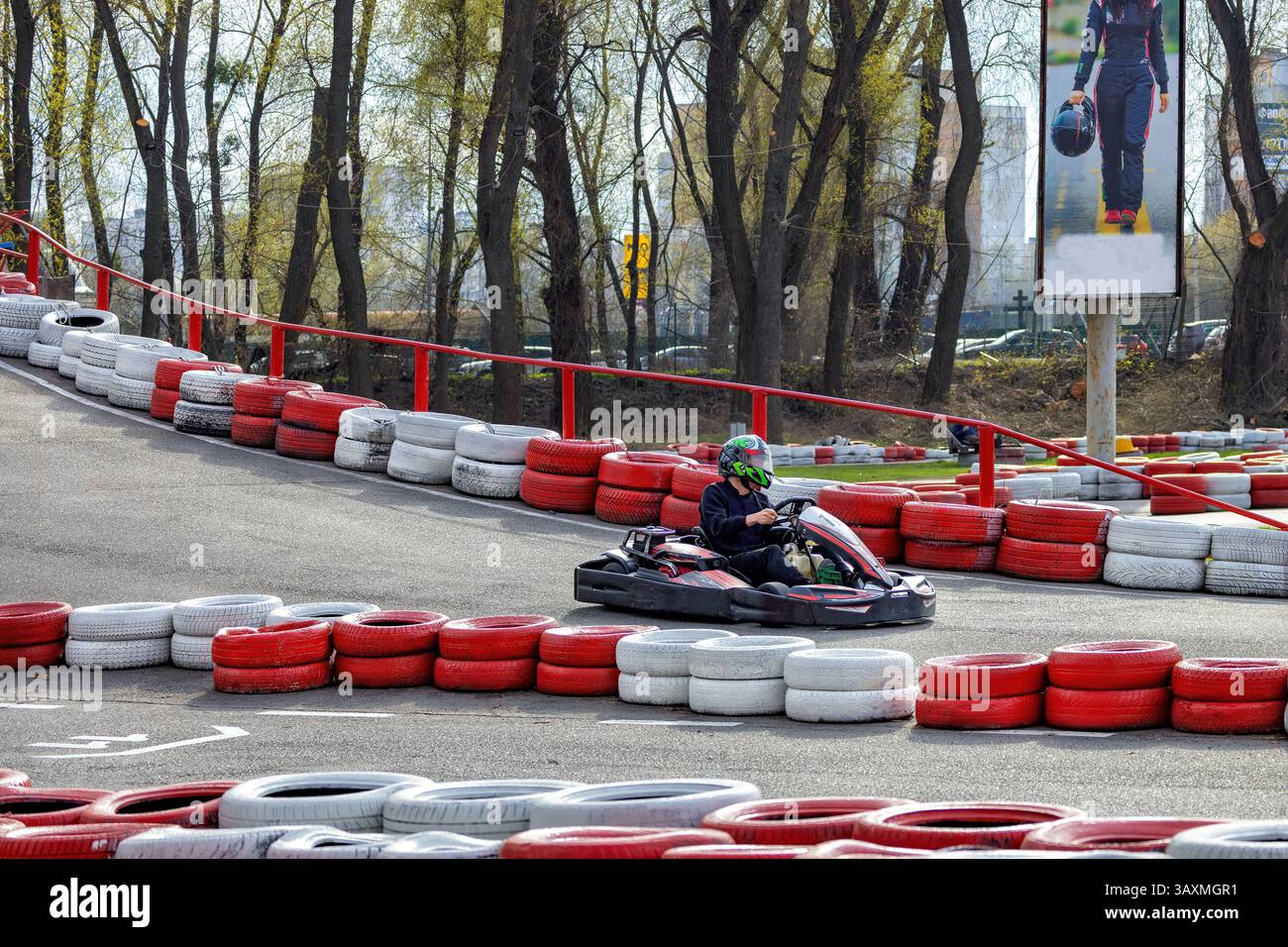 A driver navigates a colorful go-kart track, expertly maneuvering ...