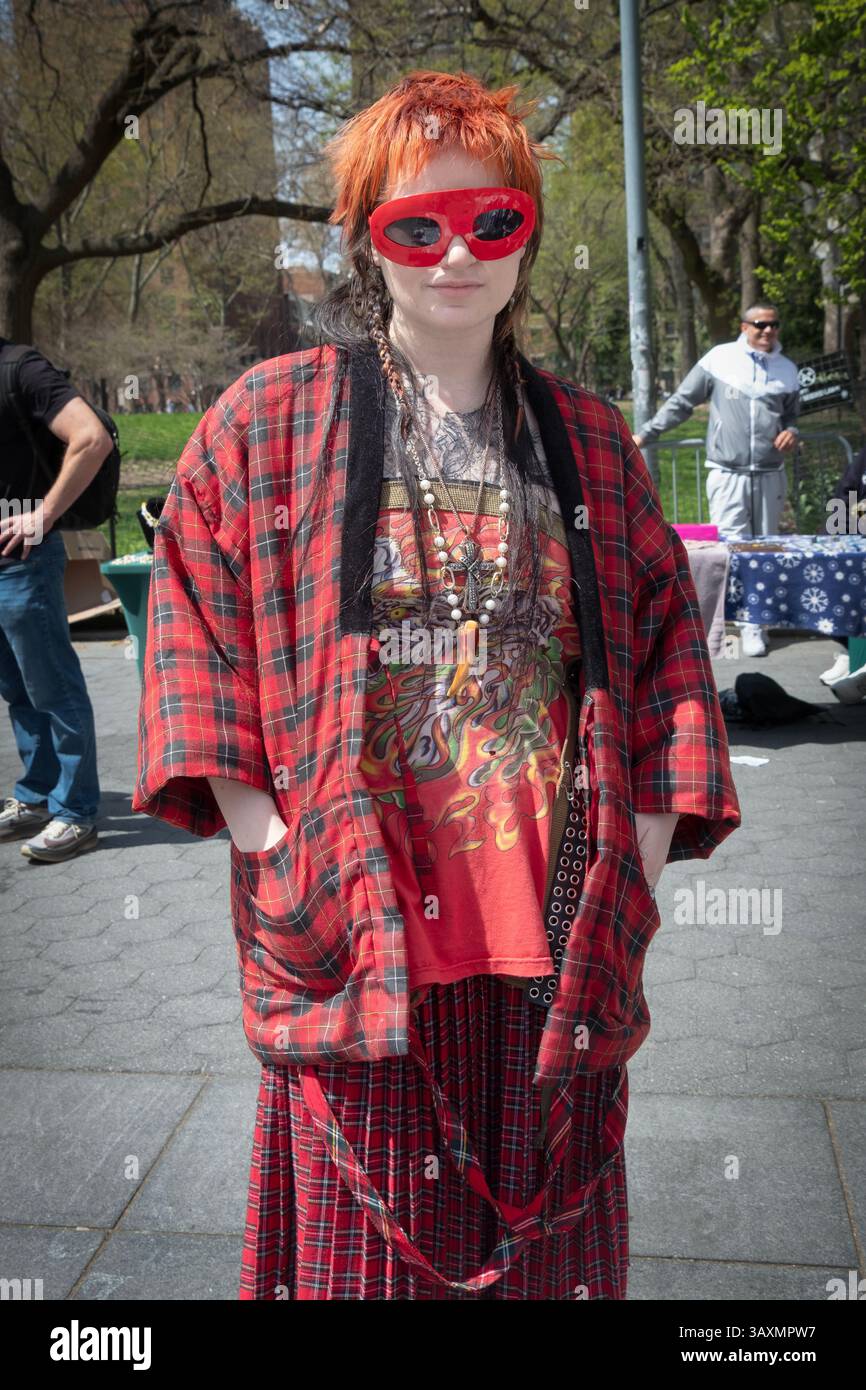Posed portrait of a woman dressed in red with red hair & red sunnies ...