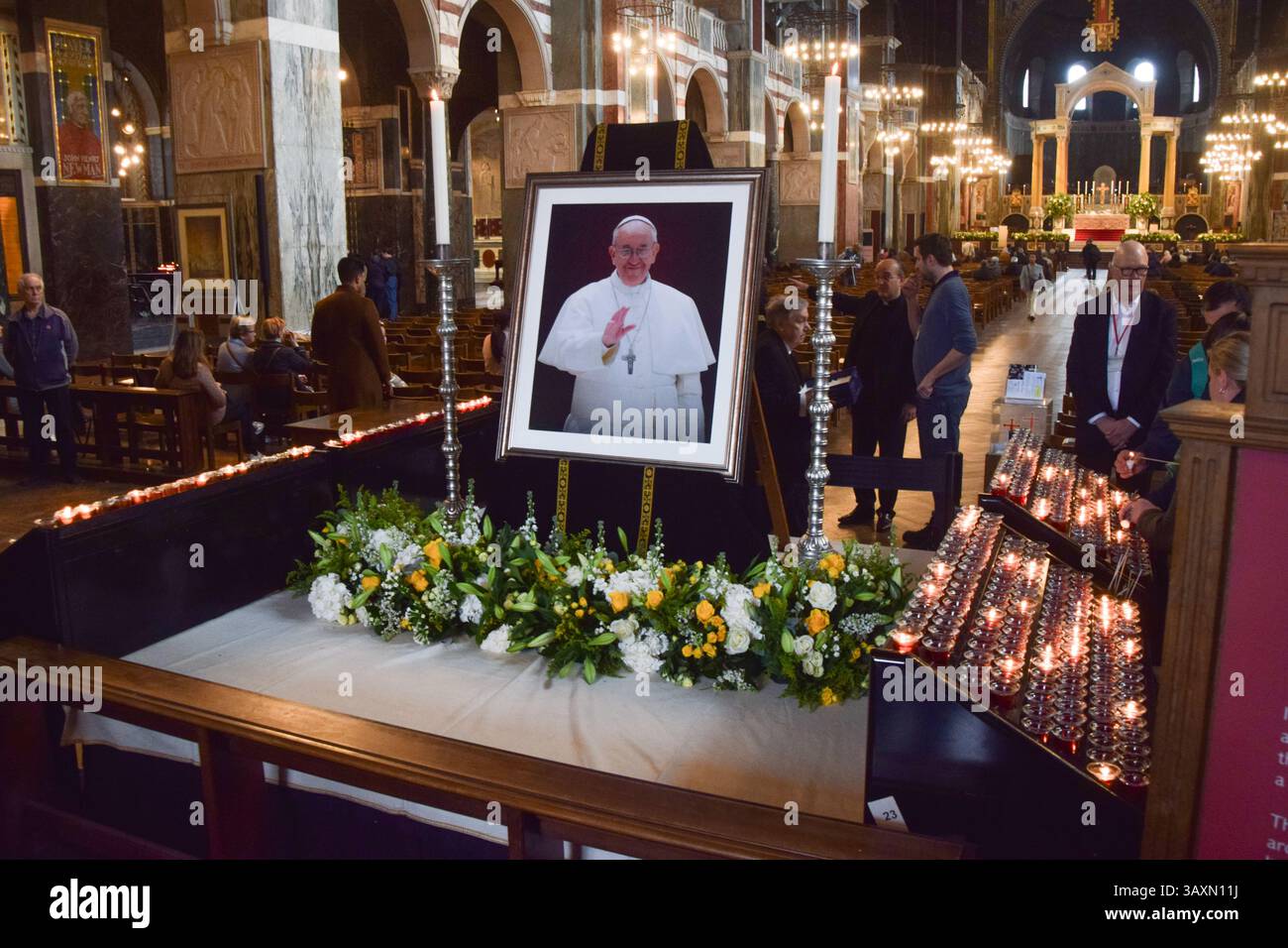 London, England, UK. 21st Apr, 2025. People light candles next to a ...