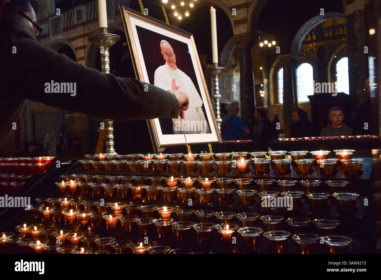 London, England, UK. 21st Apr, 2025. People light candles next to a ...