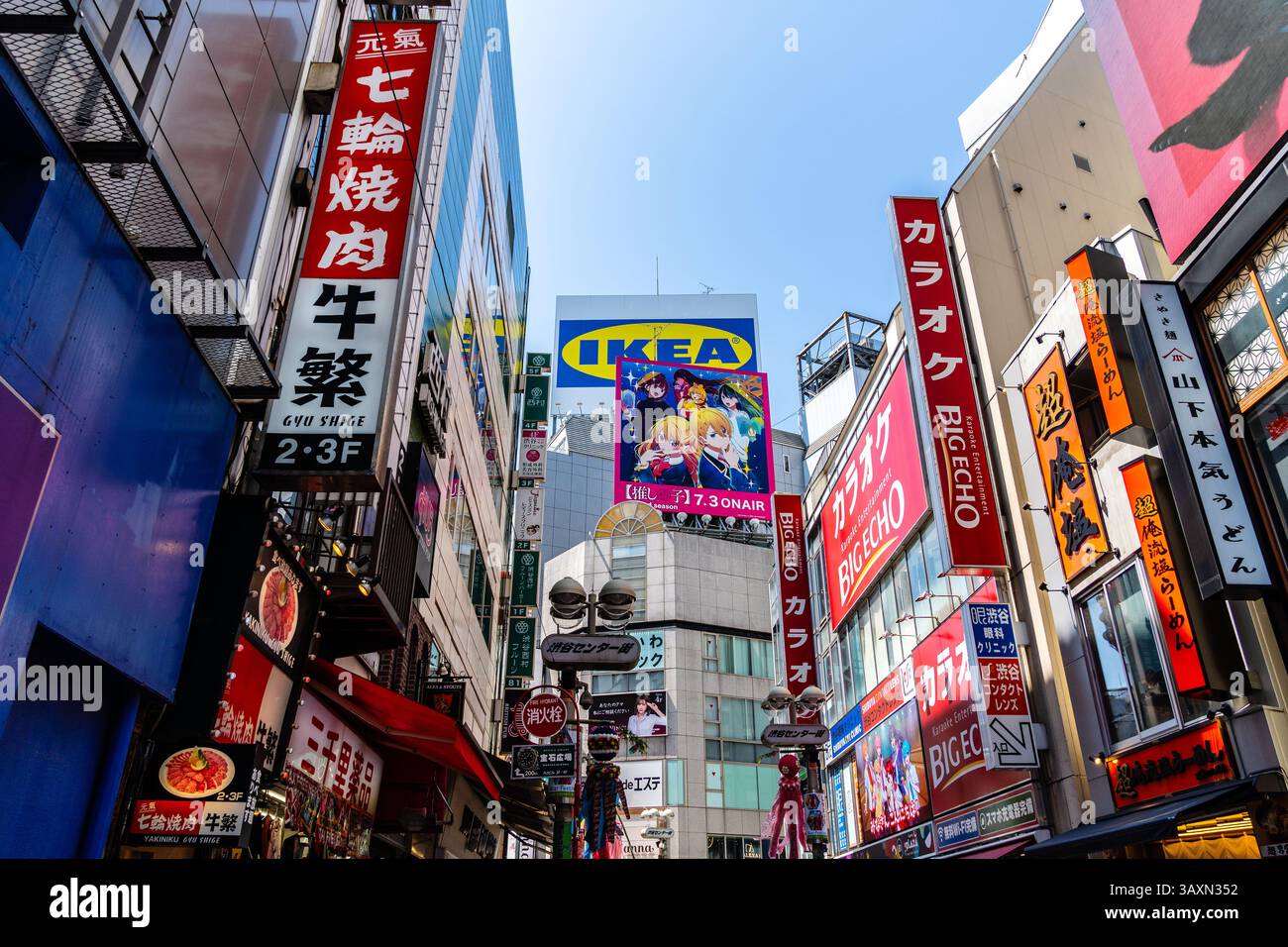Tokyo, Japan - August 4, 2024: A vibrant street view showcases the eclectic architecture and ...