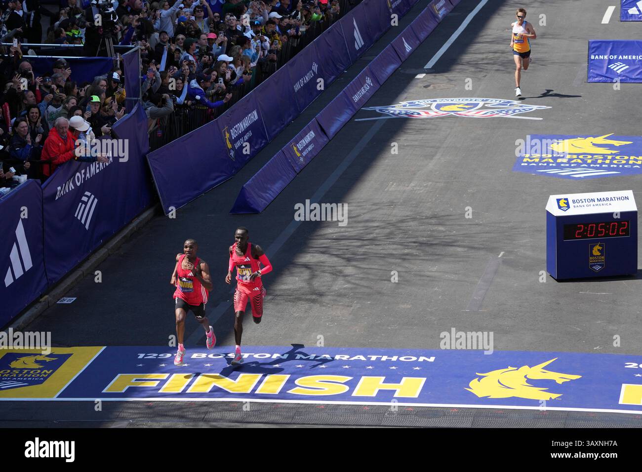 Conner Mantz, of the United States, top right, chases Alphonce Felix ...