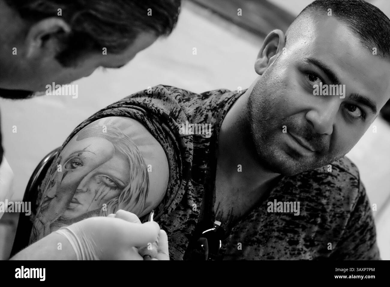 October 7, 2016 - Tel Aviv, Israel - A tattoo artist tattoos a man's ...