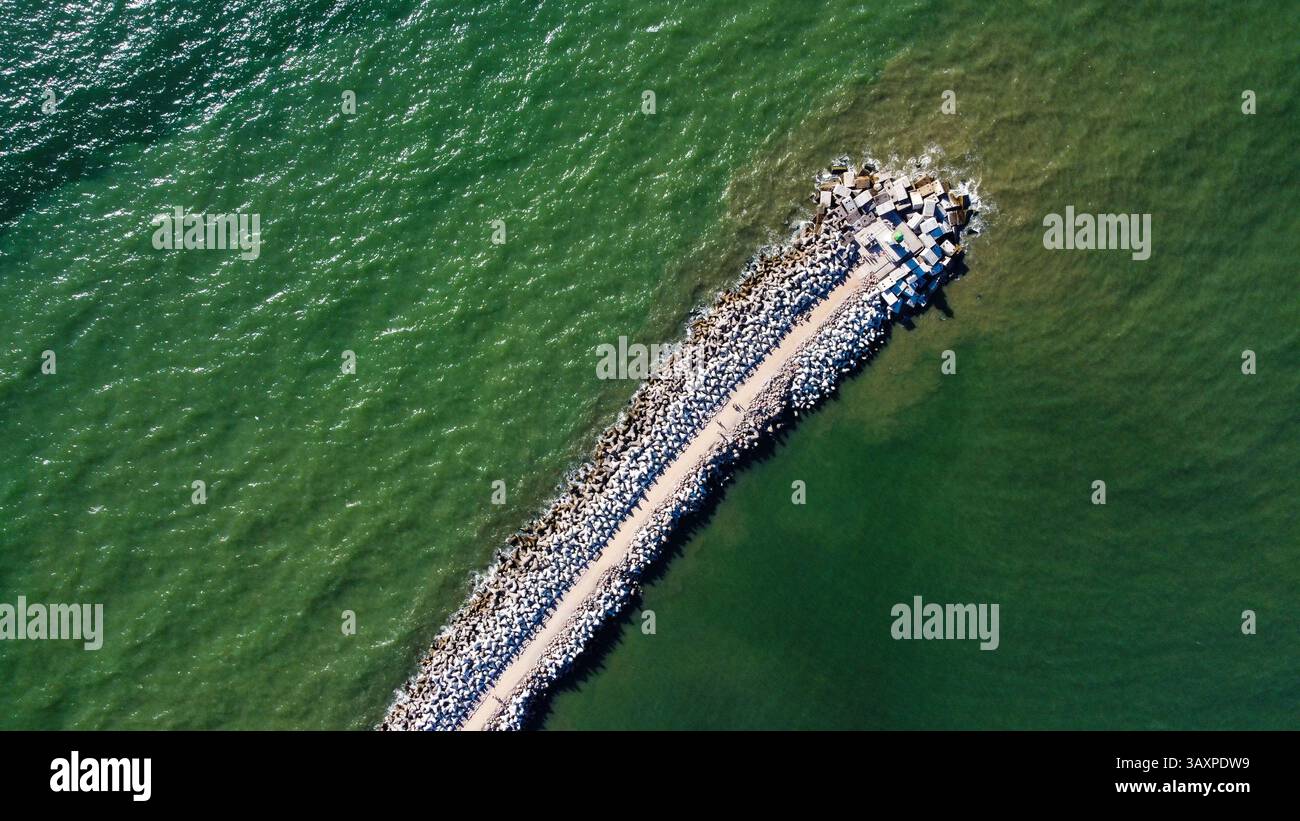 Aerial View of Breakwater Pier with Tetrapods Stretching into Sea Stock ...
