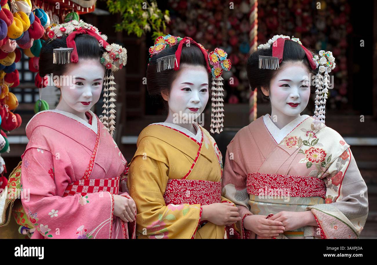 Three female tourists dressed up like maiko (apprentice geisha) touring ...