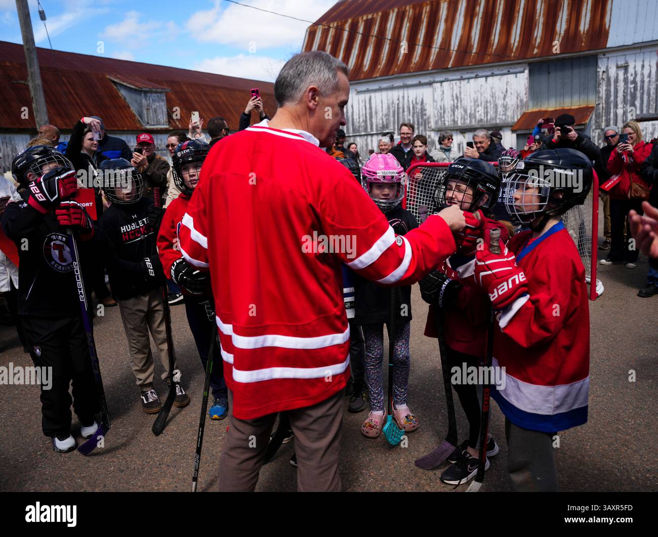 Canada Liberal Leader Mark Carney plays ball-hockey with a youngster as ...