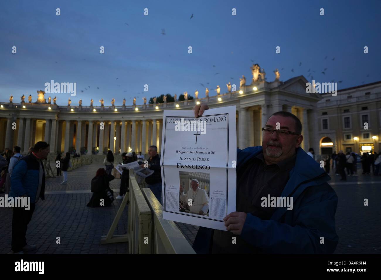 A man shows a copy of Vatican's L'Osservatore Romano paper after a ...