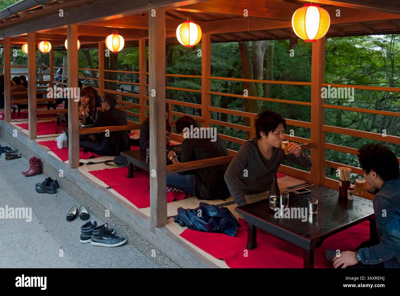 Visitors to Kiyomizu-dera Temple relaxing at Rokkatei chaya for an afternoon snack at low tables ...