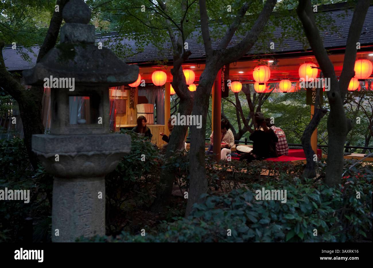 Visitors to Kiyomizu-dera Temple relaxing at Rokkatei chaya for an evening snack at low tables ...