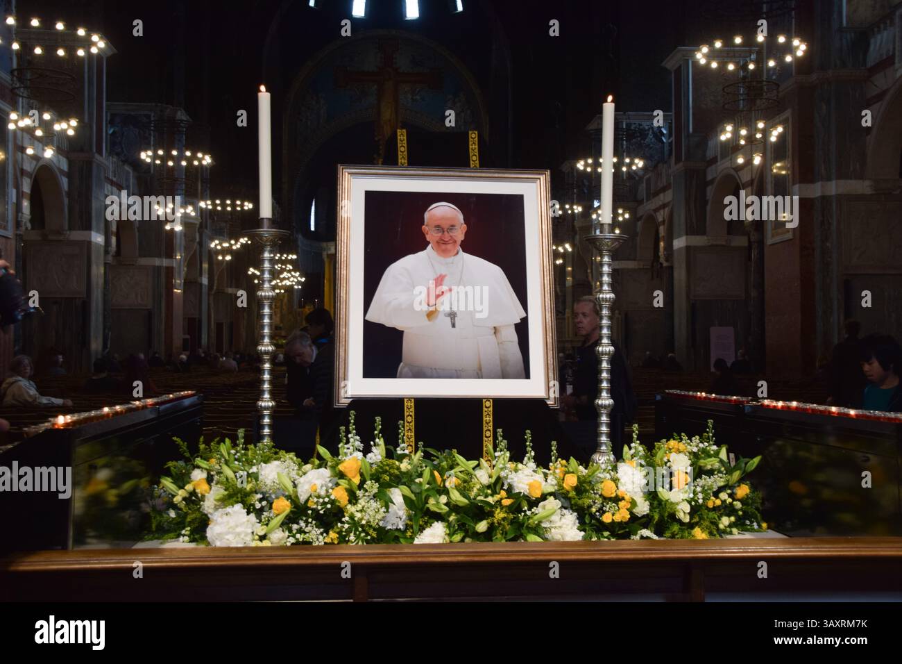 London, UK. 21st April 2025. Floral tributes next to a picture of Pope ...