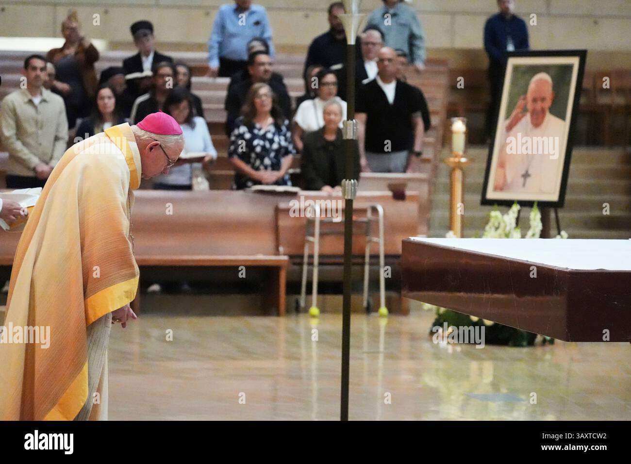 A priest bows before an altar during a service in honor of Pope Francis ...