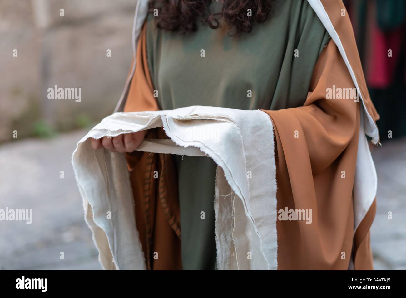 Woman wearing period costume holding white linen cloth for wrapping ...