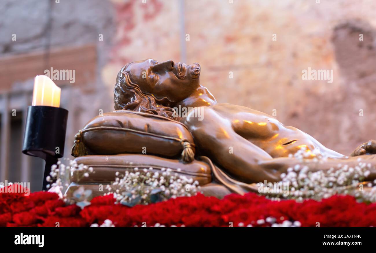 Bronze statue of Jesus Christ lying on a pillow after his death and ...