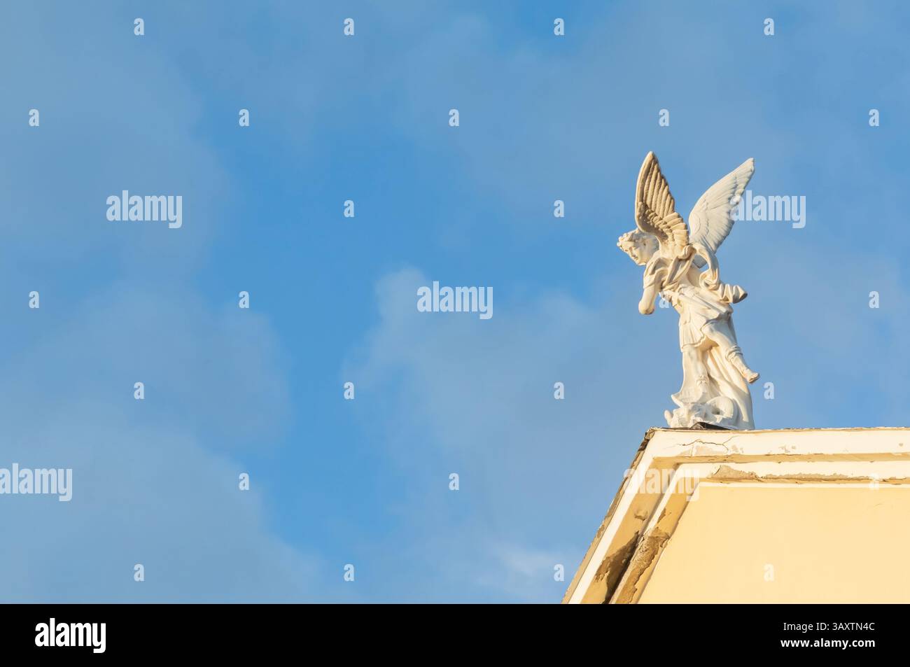 White statue of Saint Michael the Archangel slaying the Devil, placed ...