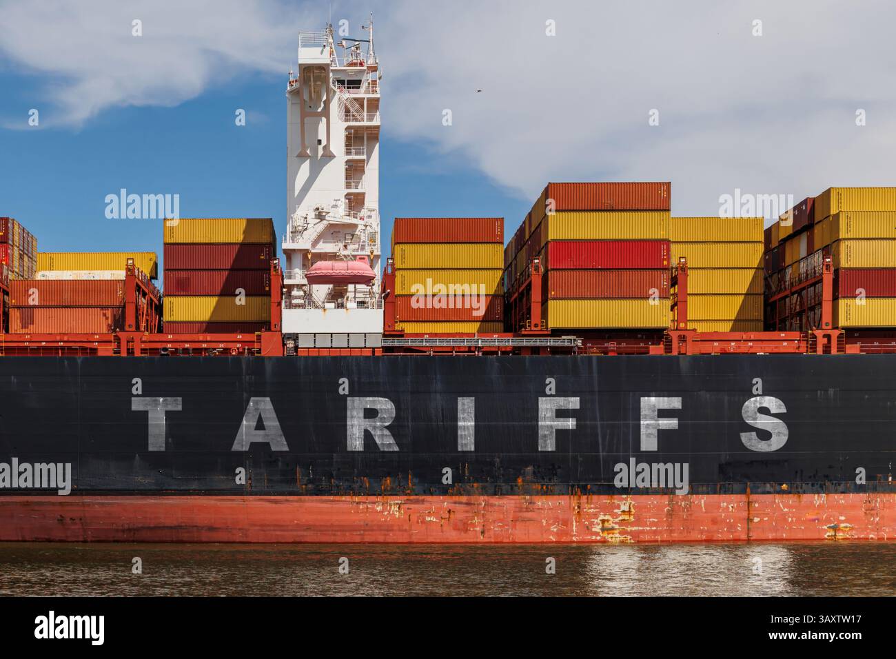 Cargo ship with containers and the word TARIFFS on its side ...