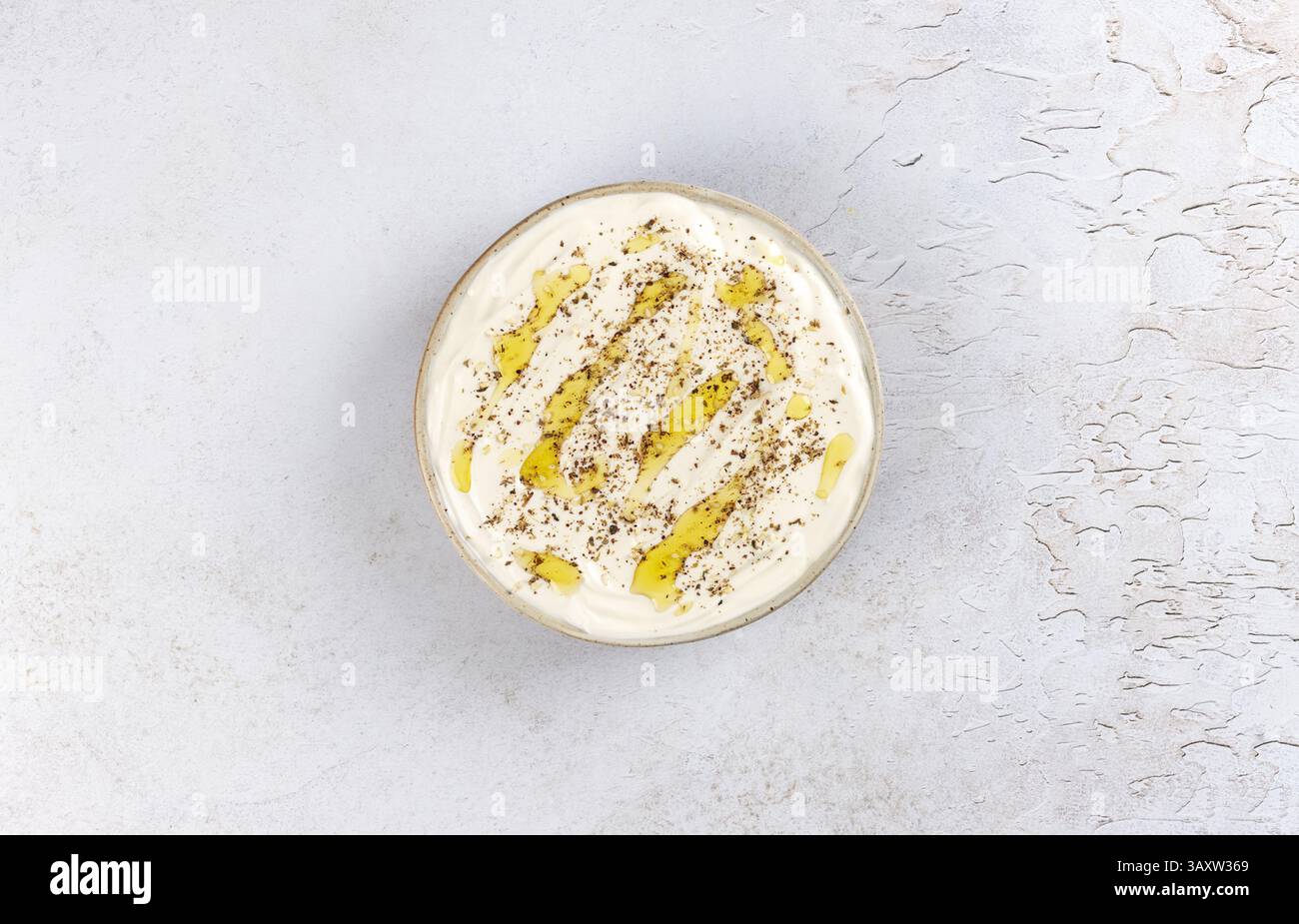 Creamy yoghurt cheese labneh with olive oil and za'atar on white ...