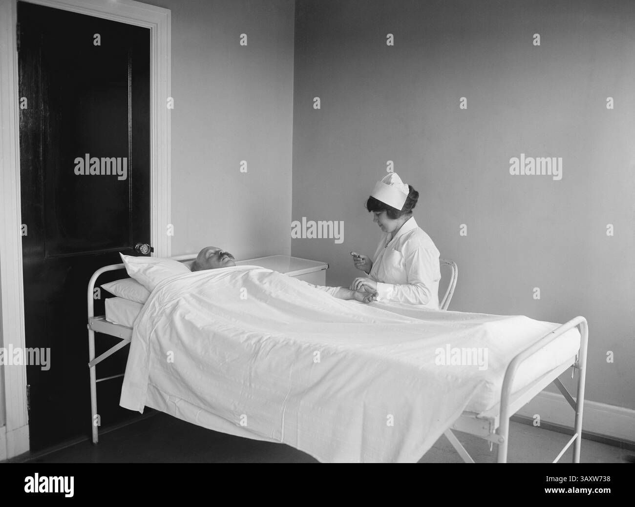 Nurse checking pulse rate Black and White Stock Photos & Images - Alamy