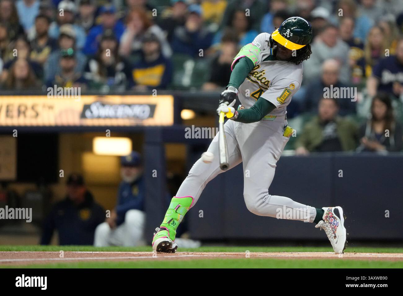 Athletics' Lawrence Butler hits a single during the first inning of a ...