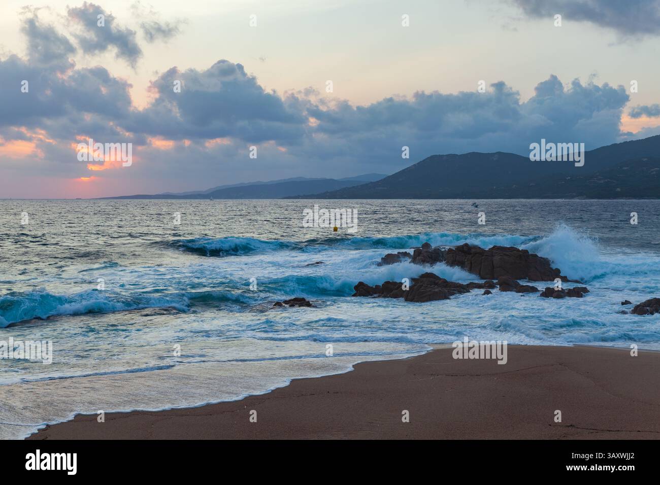 A picturesque shoreline with rocky formations, gently lapping waves ...