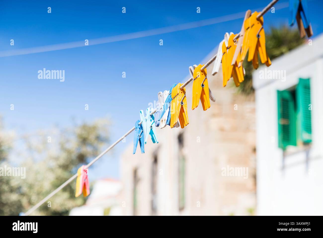 Colourful pegs on a washing line in a garden in Chalki, Greece Stock ...