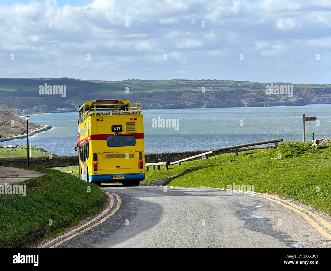 Whitby Town Open Top Bus Tour driving past Whitby Abbey Stock Photo - Alamy