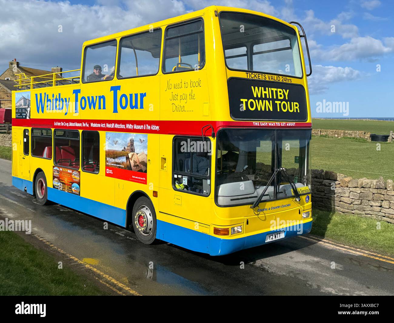 Whitby Town Open Top Bus Tour driving past Whitby Abbey Stock Photo - Alamy