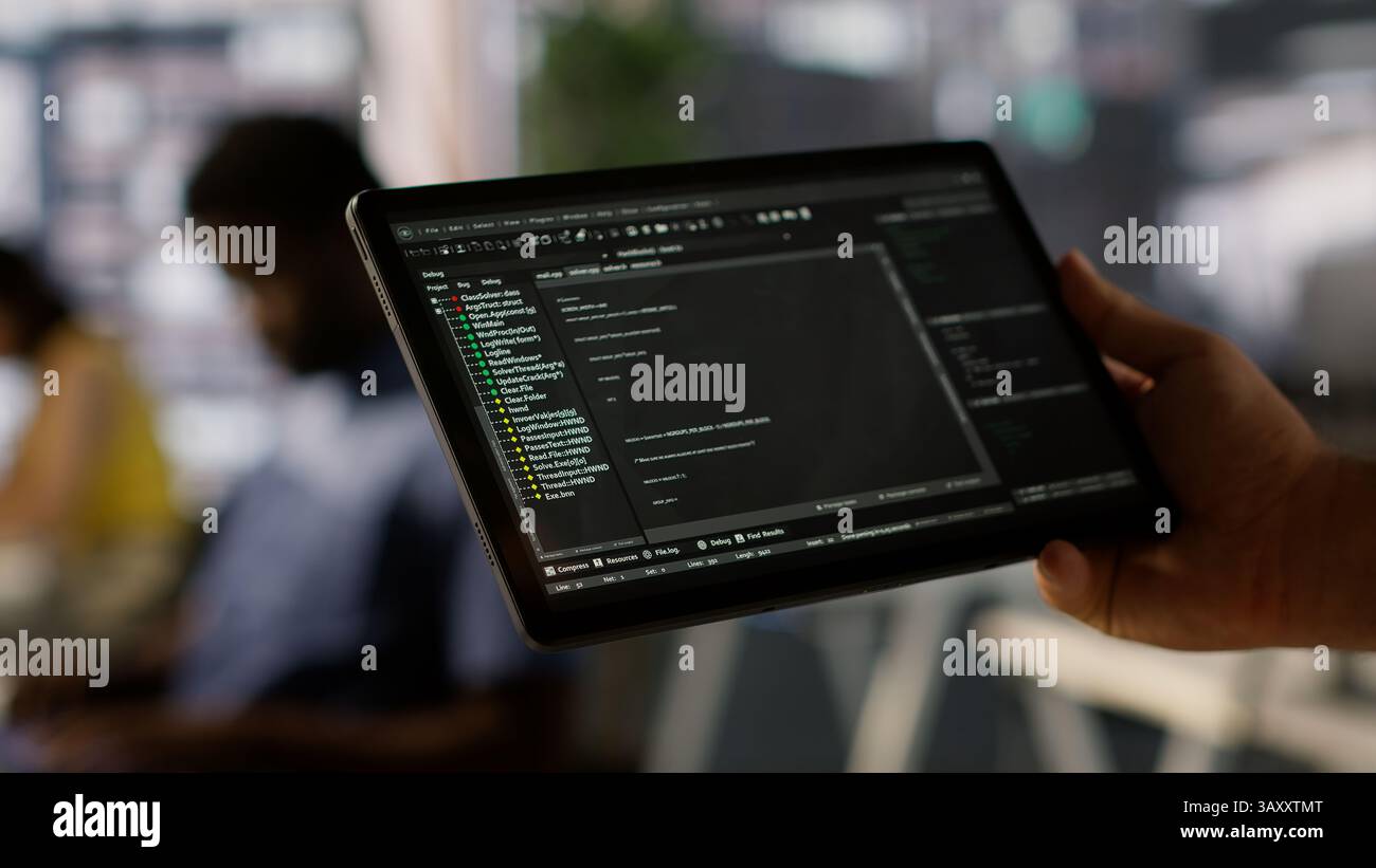 Data scientist uses tablet to check on machine learning models that can analyze data to automate ...