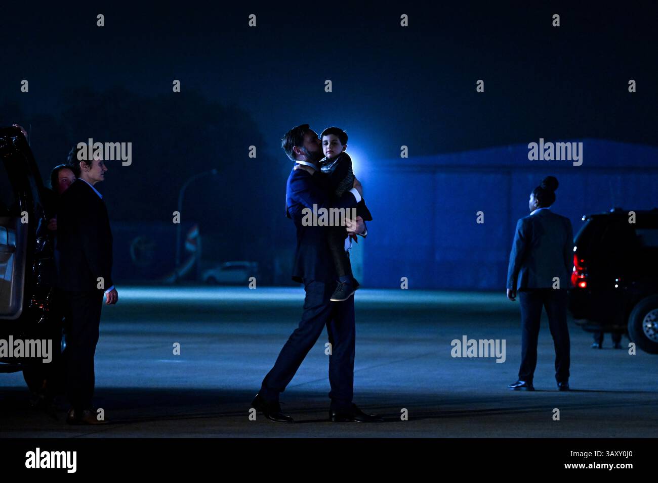 U.S. Vice President JD Vance carries his son Vivek across the tarmac to ...