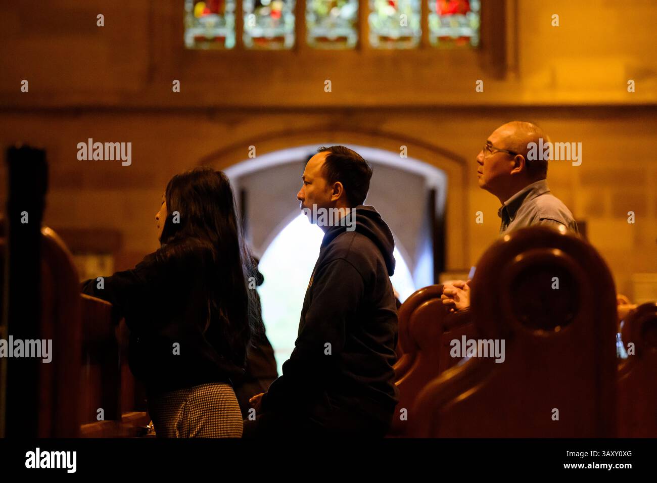 Members of the congregation pray during a service mourning the death of ...