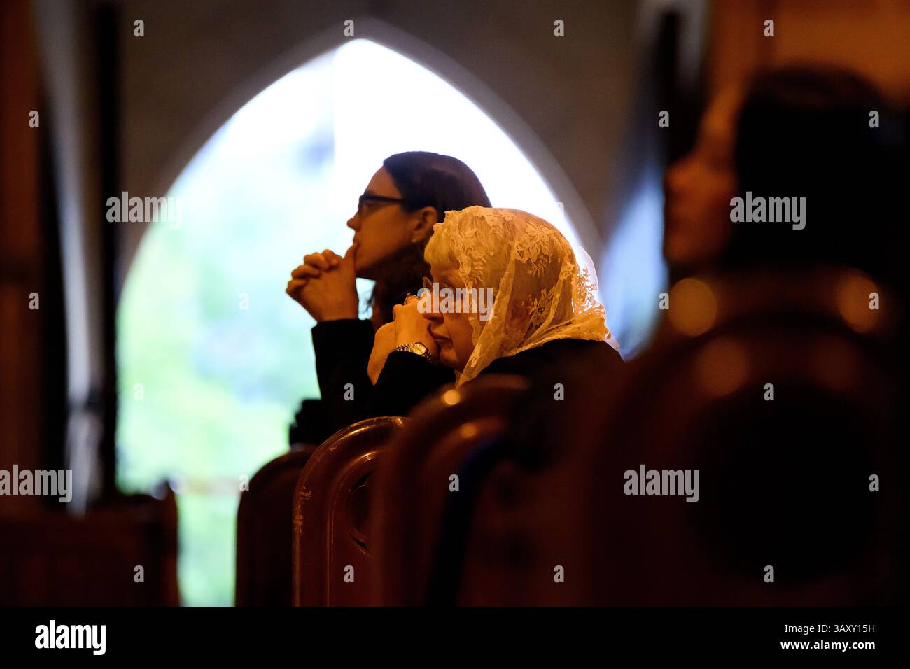 Members of the congregation pray during a service mourning the death of Pope Francis, St Mary's ...