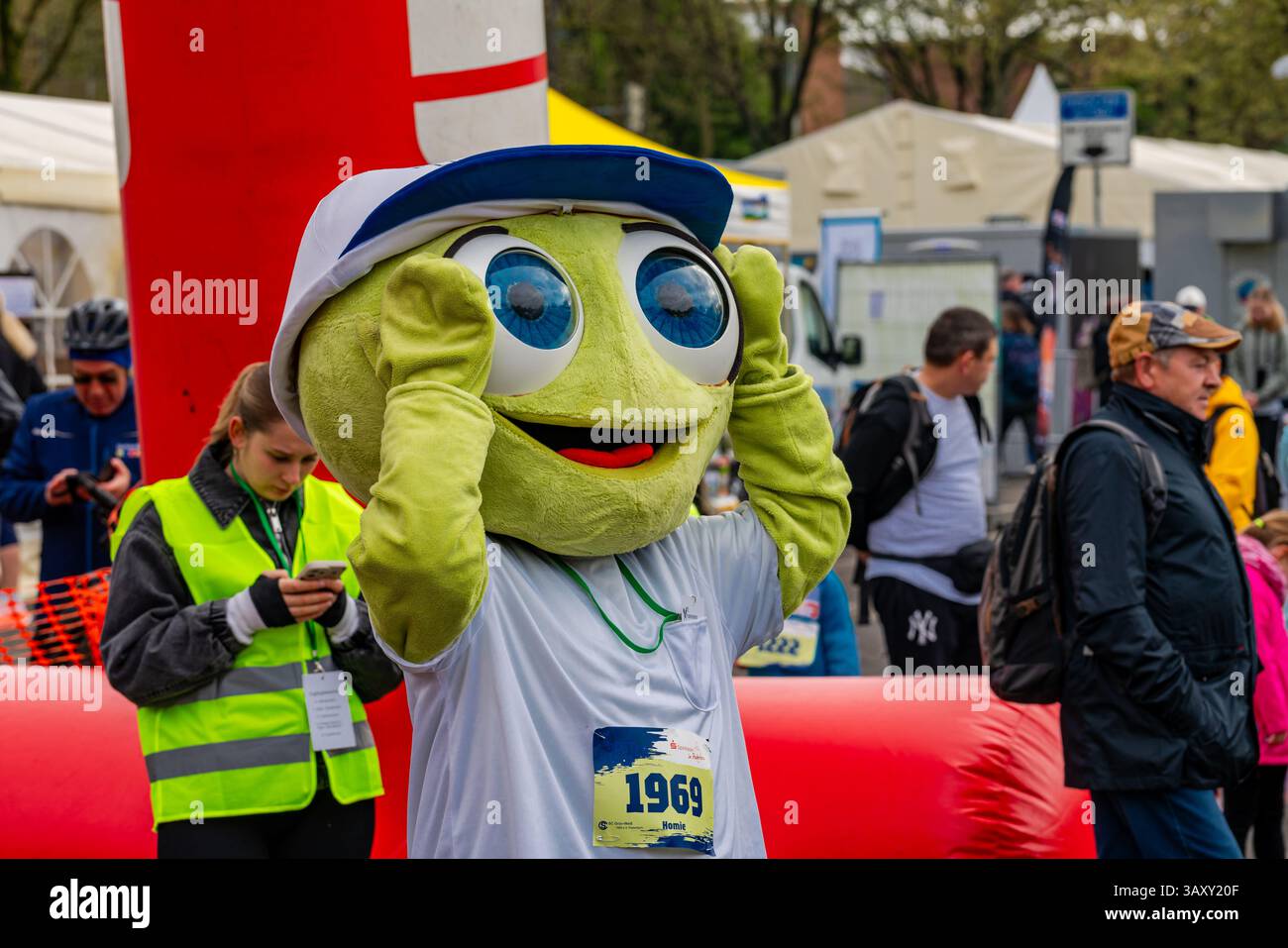 GERMANY, PADERBORN, 77 EASTER RUN - 04-19-2025. A large, green mascot ...