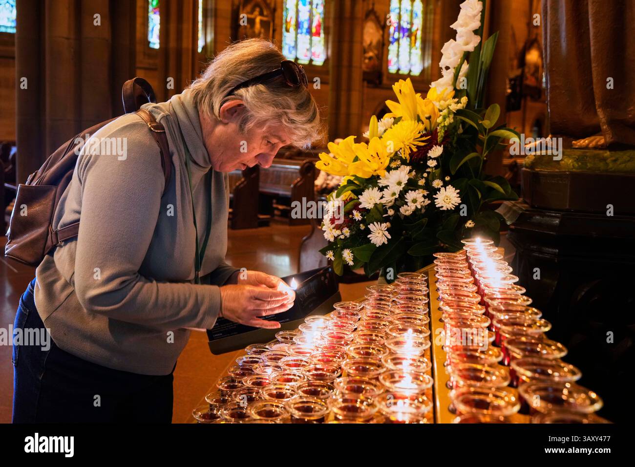 Suzanne Jessep lights a candle at Sydney's St Mary's Cathedral ...