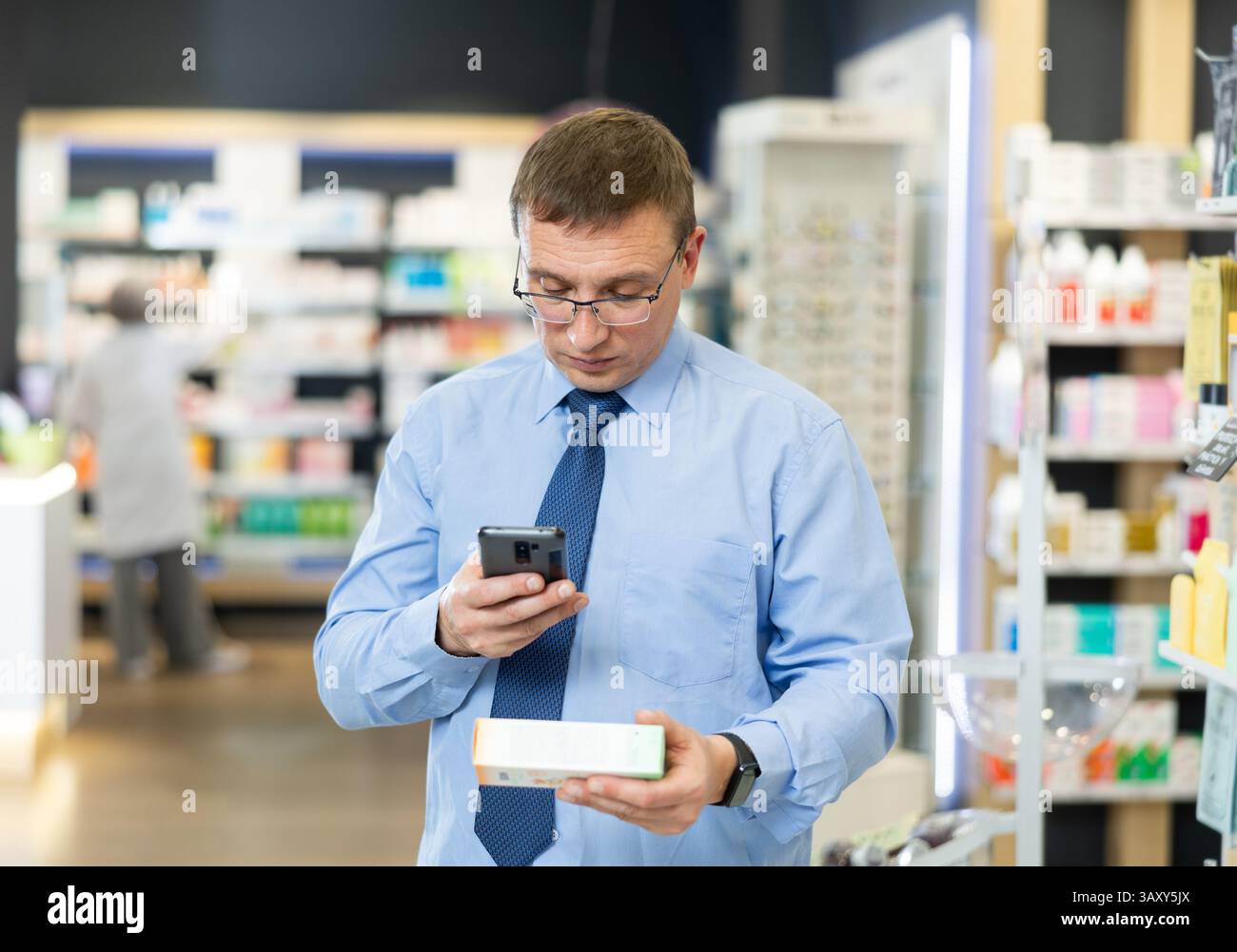 In pharmacy man visitor scan QR Code and reads composition of cream for ...