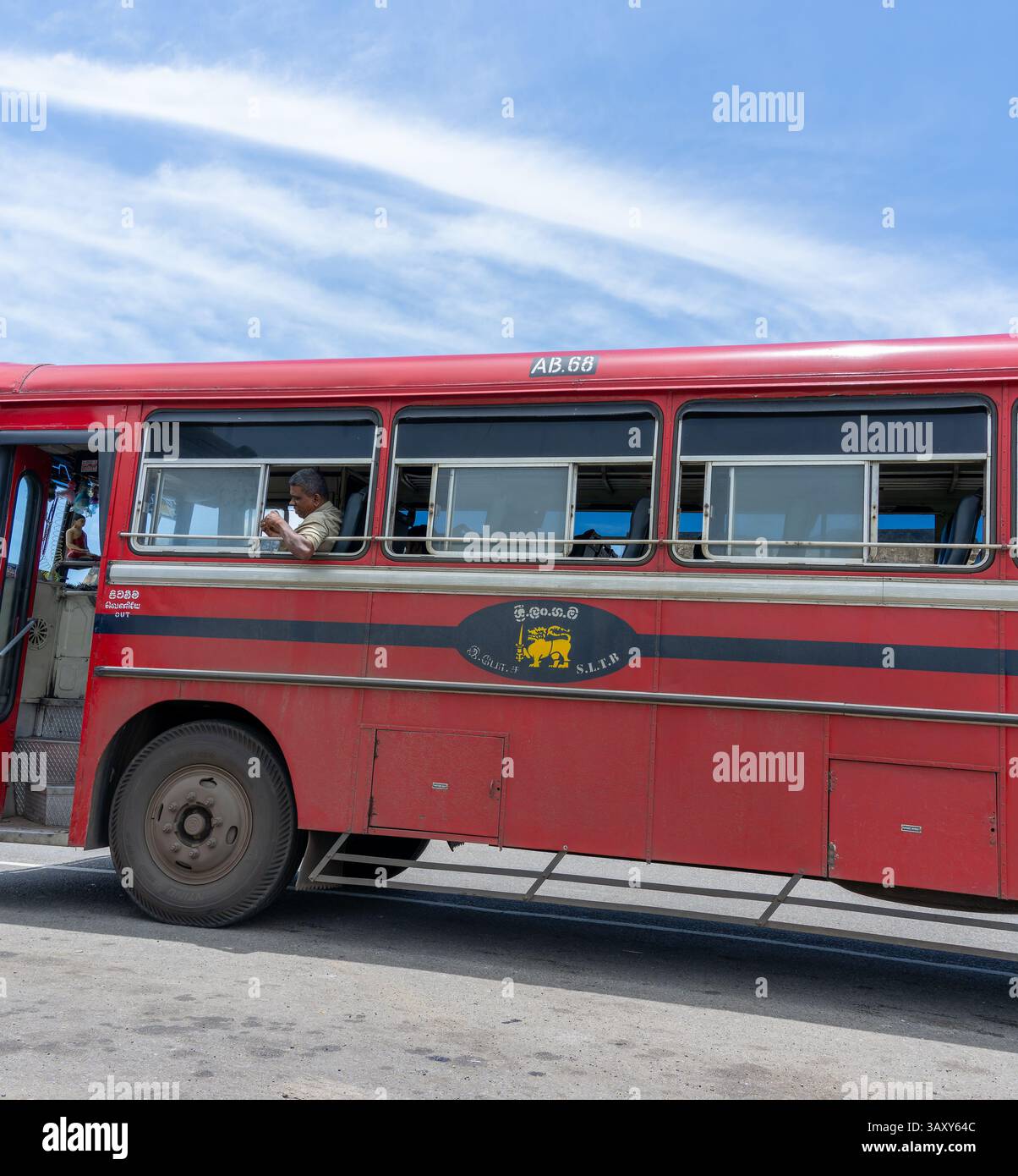 Galle Sri Lanka - September 14 2024; Red bus in street with mans arm ...