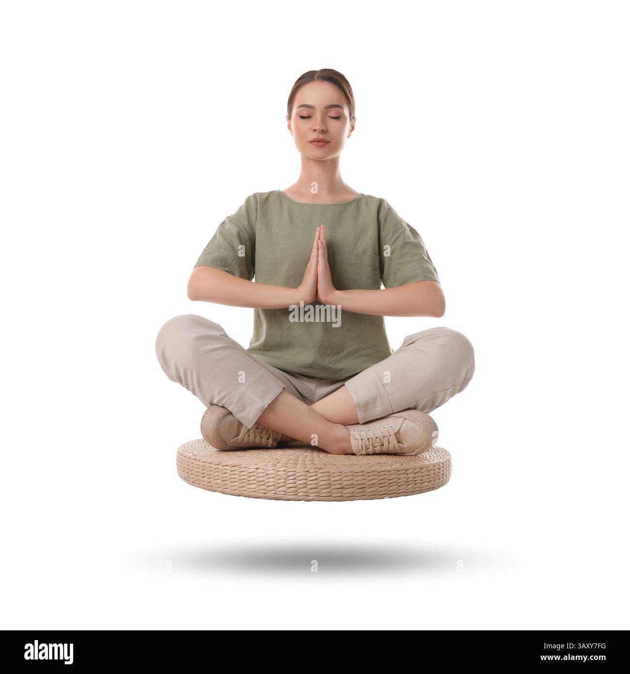Young woman levitating during meditation on white background ...