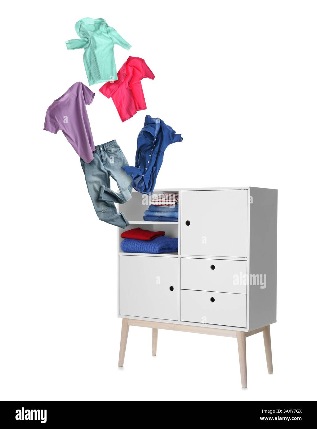 Clothes flying out of shelving unit on white background Stock Photo - Alamy