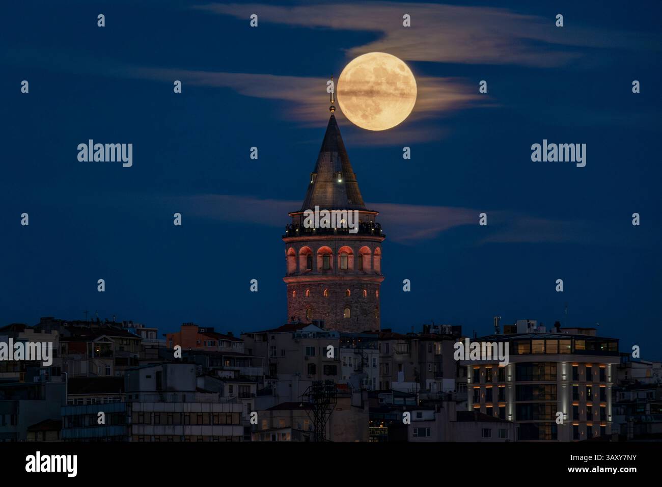 Full moon rising from behind Galata Tower in Istanbul 11.04.2025 ...