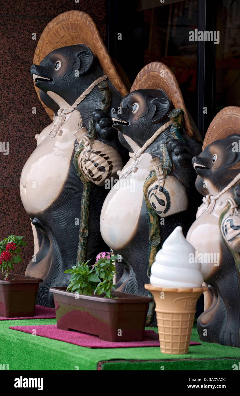 A tanuki (raccoon dog) figure ubiquitous in Japan symbolizing good luck ...