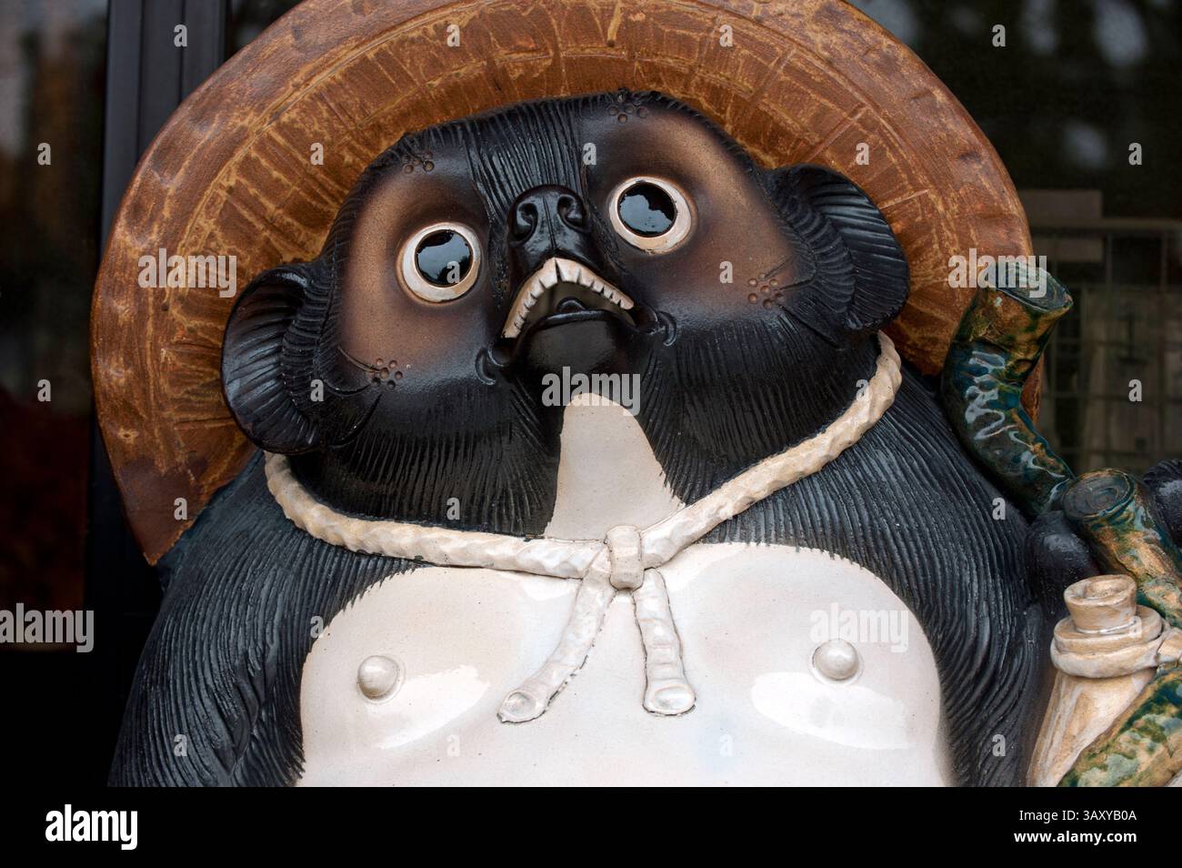 A tanuki (raccoon dog) figure ubiquitous in Japan symbolizing good luck ...