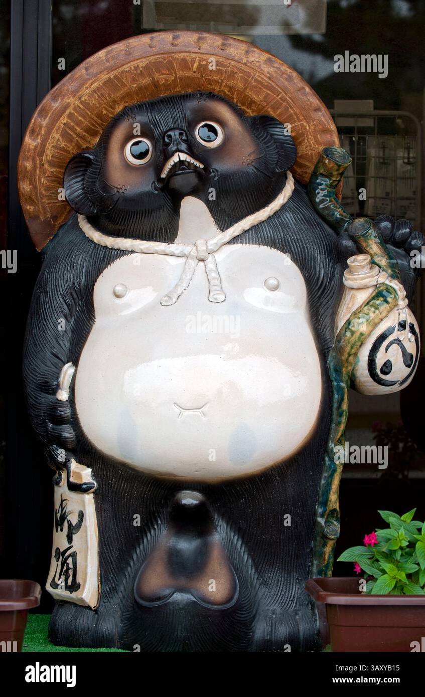A tanuki (raccoon dog) figure ubiquitous in Japan symbolizing good luck ...