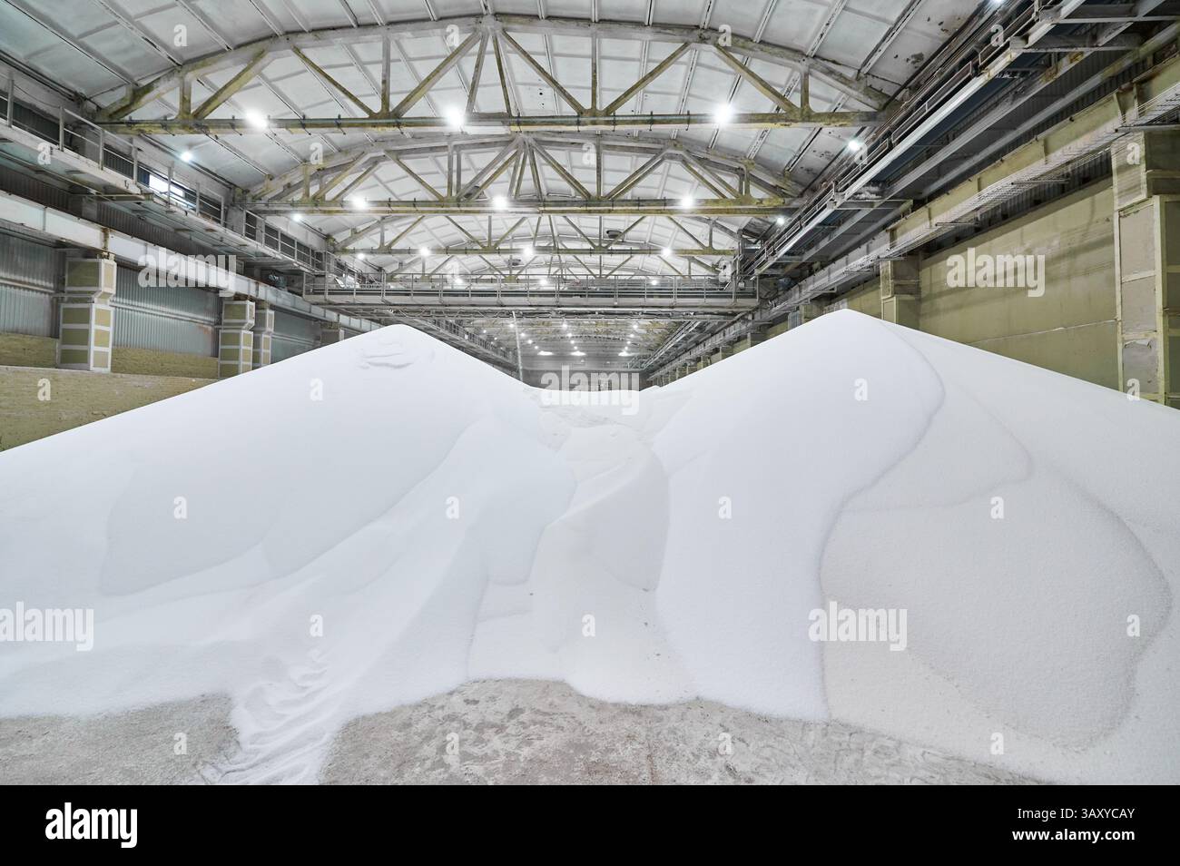 Chemical plant warehouse featuring large mounds of raw material stored ...