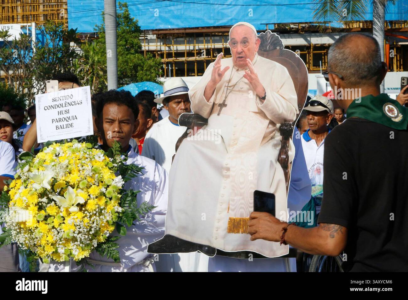 Devotees carry a cutout of the late Pope Francis during a procession ...