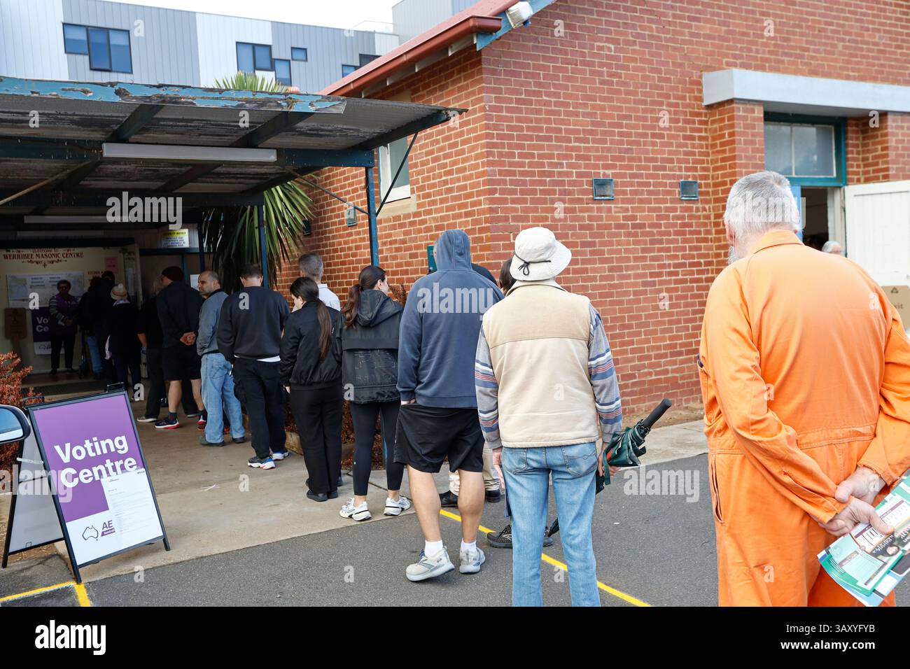 People seen lining up outside the voting centre to cast their ballots ...