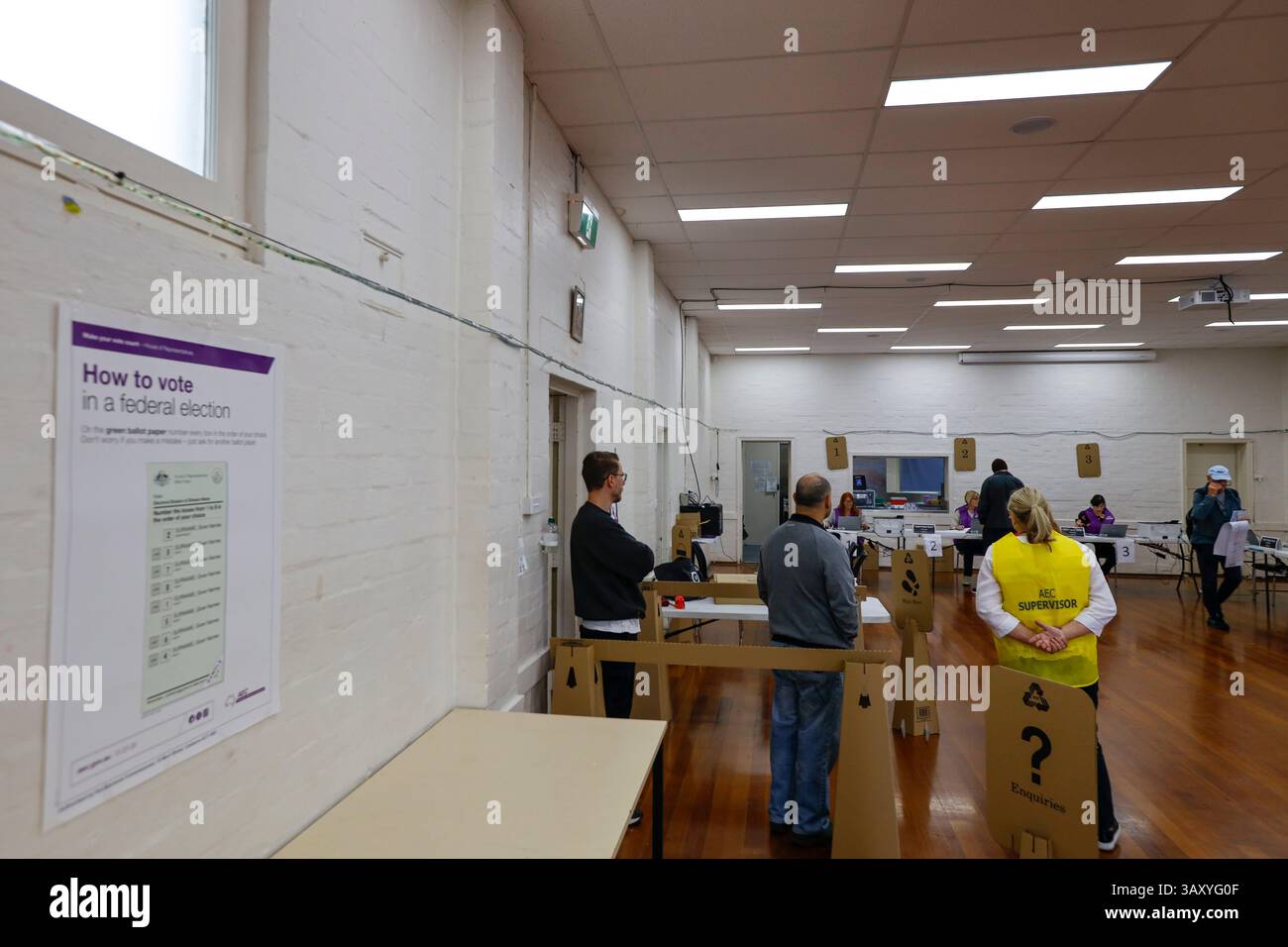 Melbourne, Australia. 22 April, 2025. Voters wait to register inside a ...