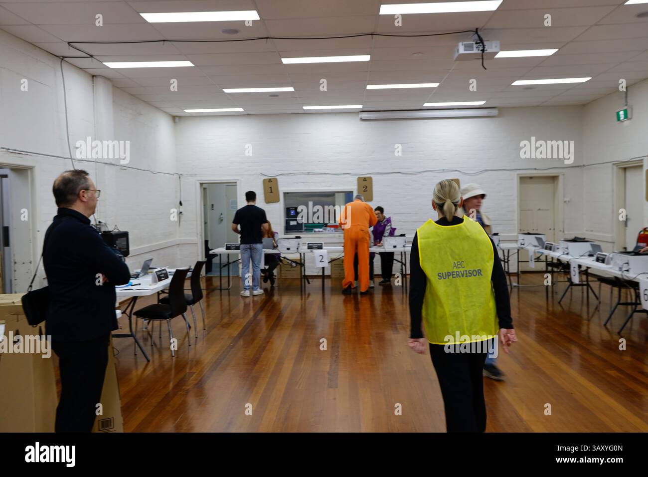 Melbourne, Australia. 22 April, 2025. Voters wait to register inside a ...