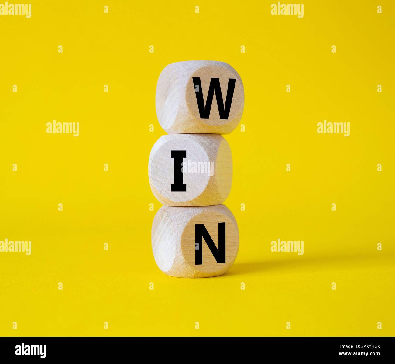 Win symbol. Wooden blocks with words Win. Beautiful yellow background ...
