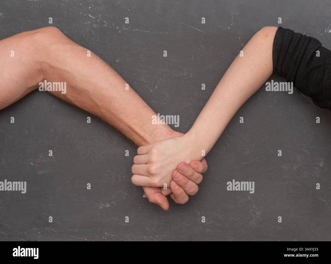 a woman defeated a man in arm wrestling Stock Photo - Alamy